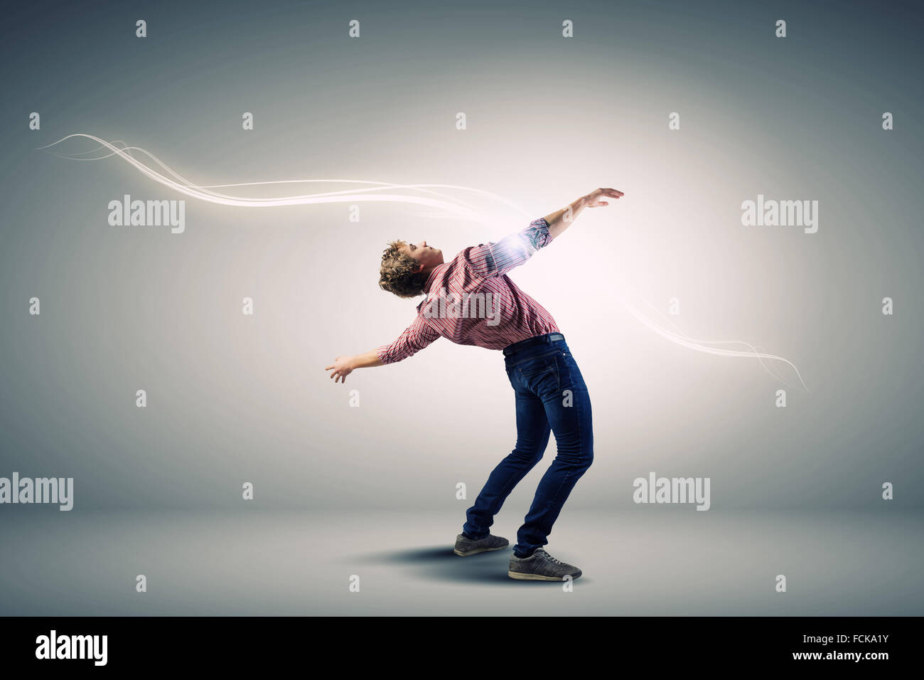 Young guy in casual evading from light rays Stock Photo - Alamy