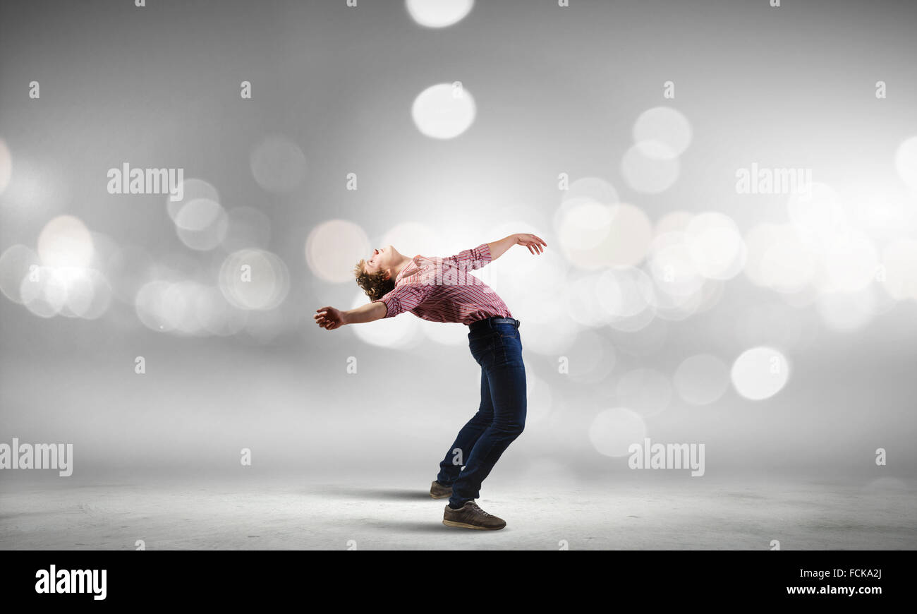 Young guy in casual evading from light rays Stock Photo - Alamy