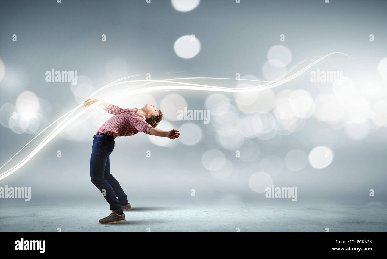 Young guy in casual evading from light rays Stock Photo - Alamy