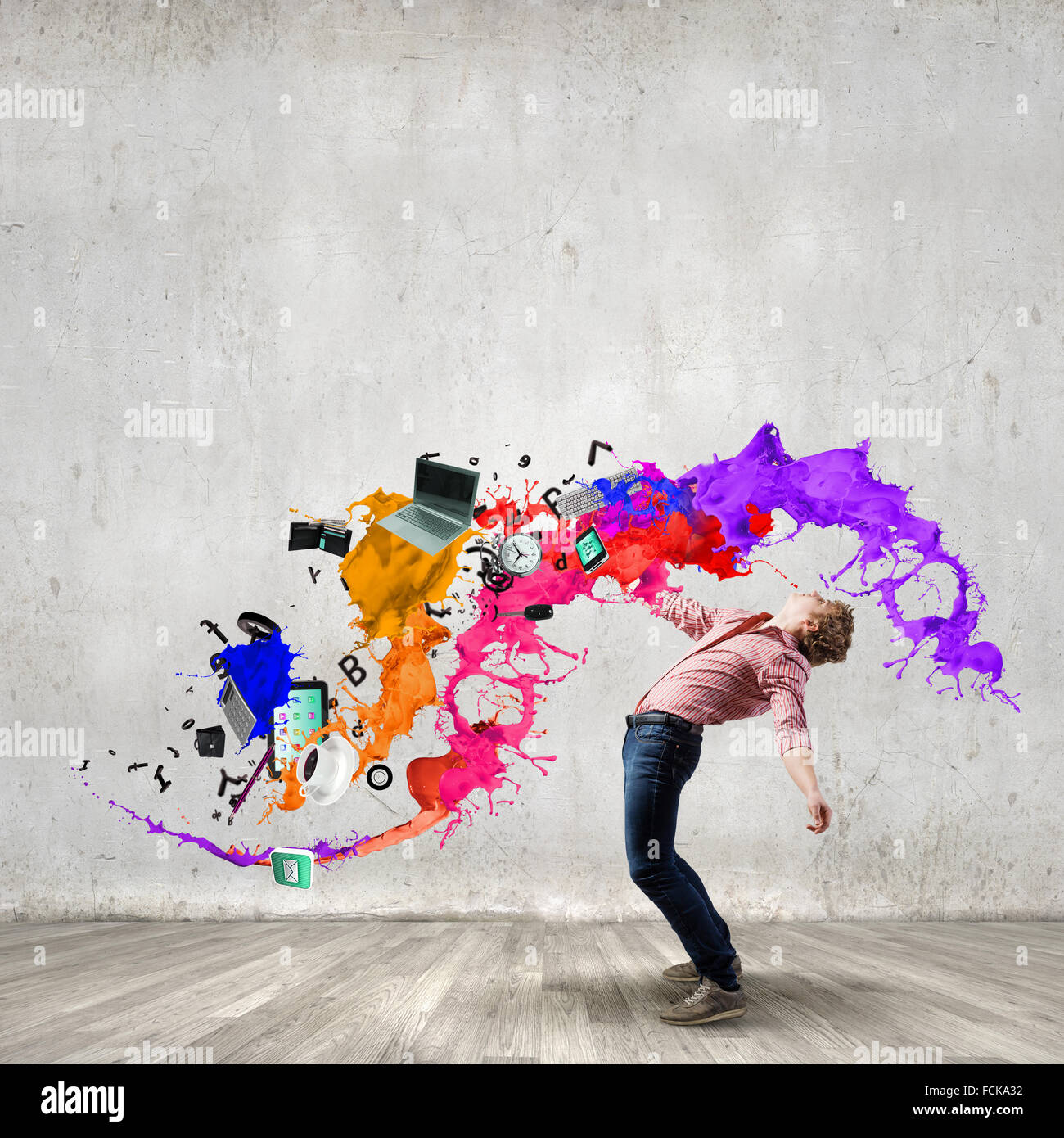 Young guy in casual evading from colorful splashes Stock Photo - Alamy