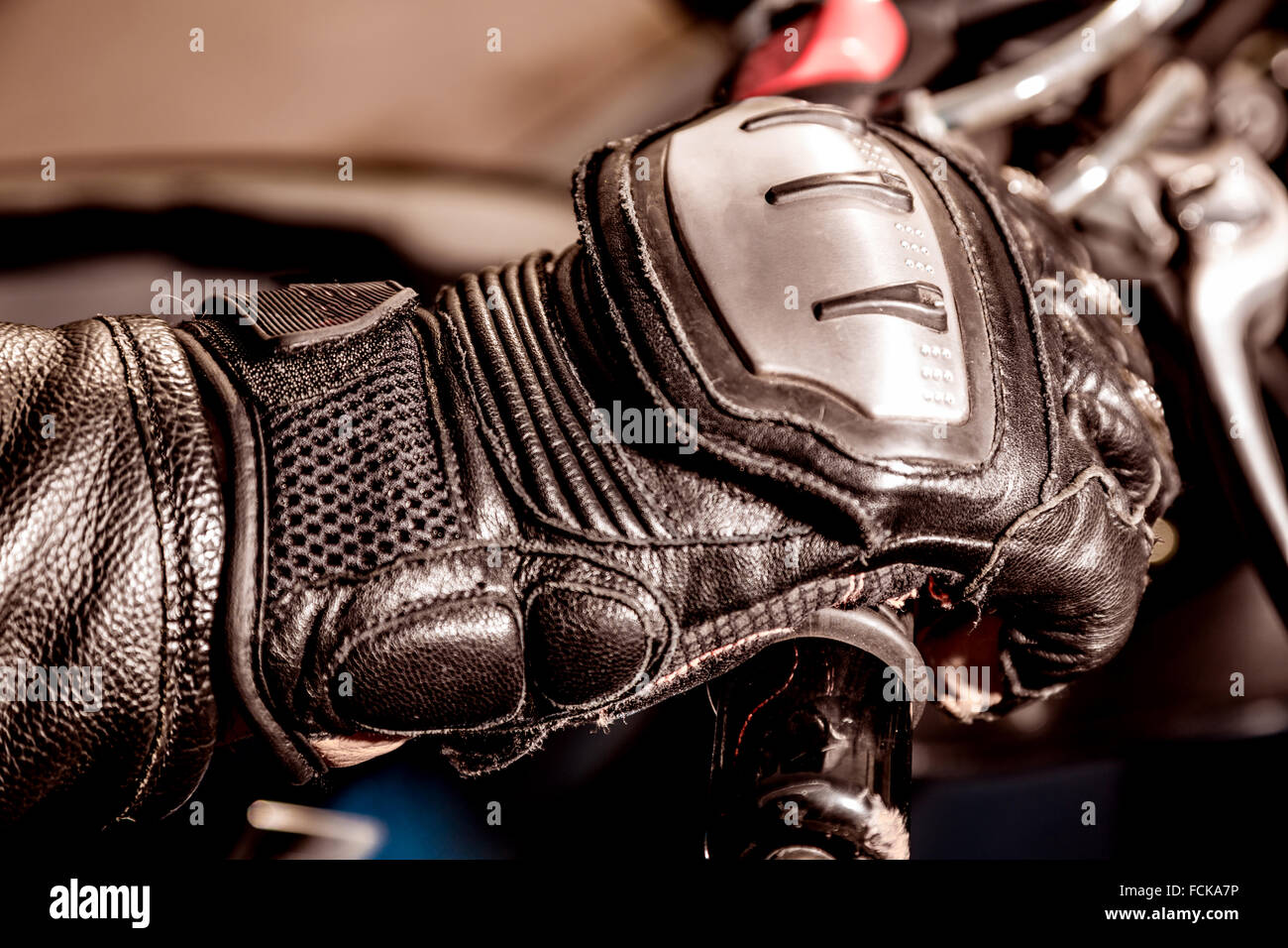 Human hand in a Motorcycle Racing Gloves holds a motorcycle throttle ...