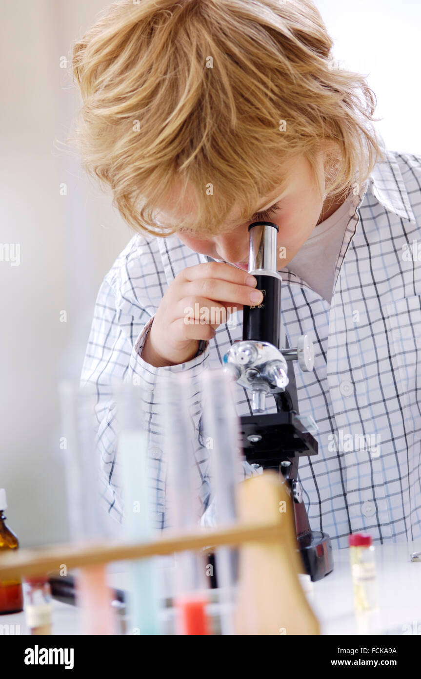 Blond little boy using microscope Stock Photo - Alamy