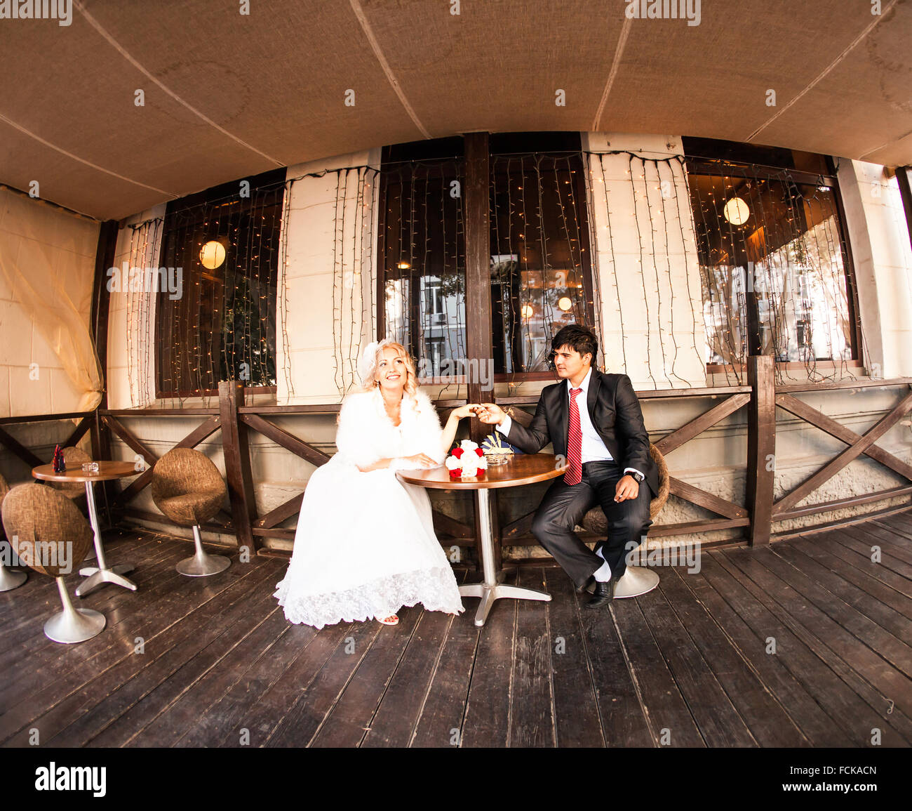 Bride and groom drinking coffee at an outdoor cafe Stock Photo - Alamy