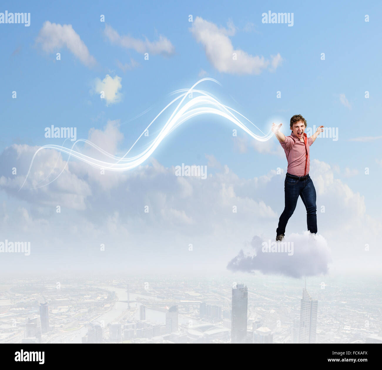 Young man in casual throwing magic light Stock Photo - Alamy