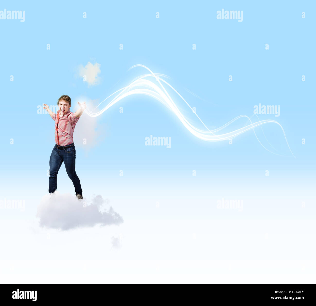 Young man in casual throwing magic light Stock Photo - Alamy