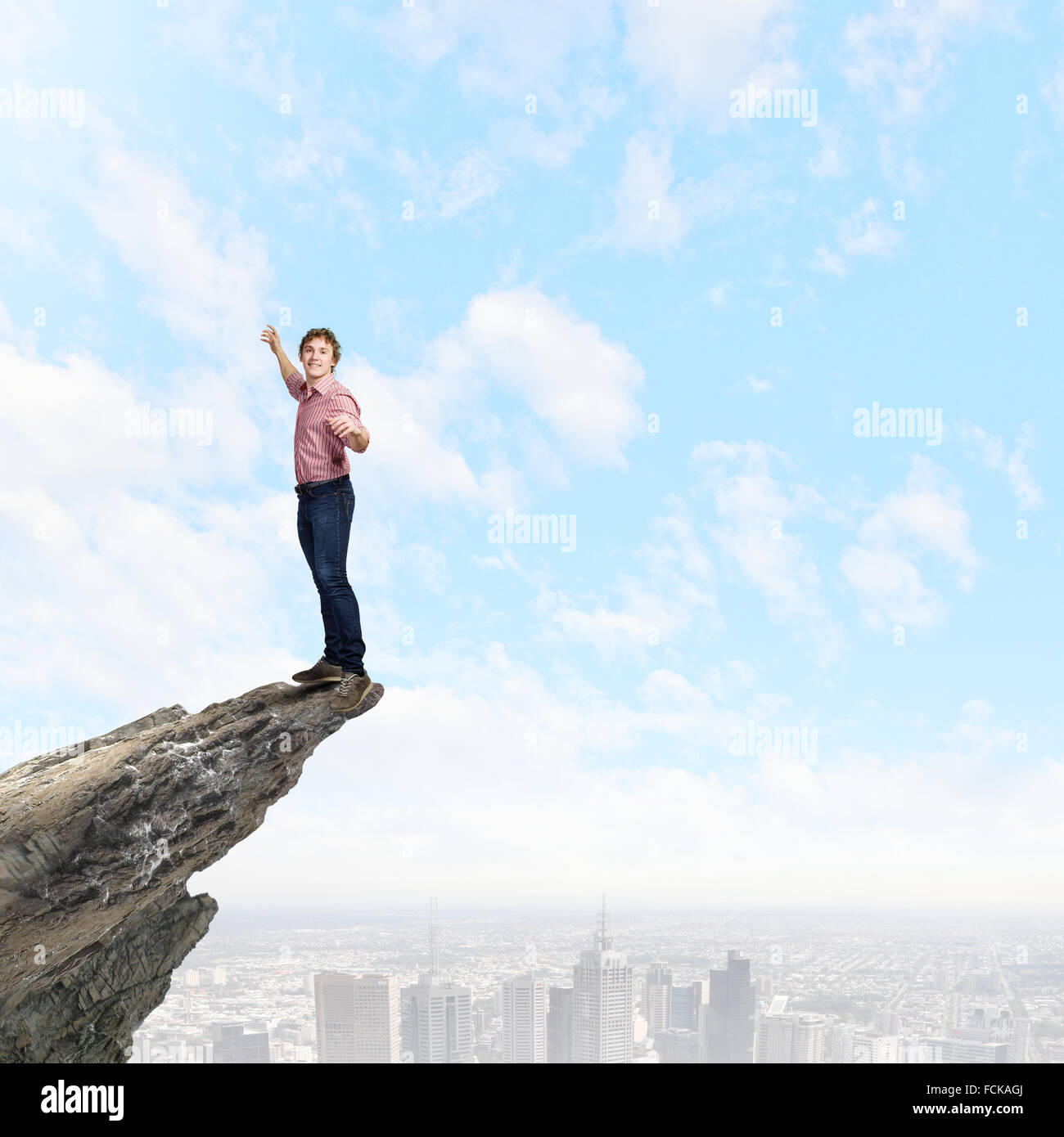 Young man balancing on one leg on edge of rock Stock Photo - Alamy