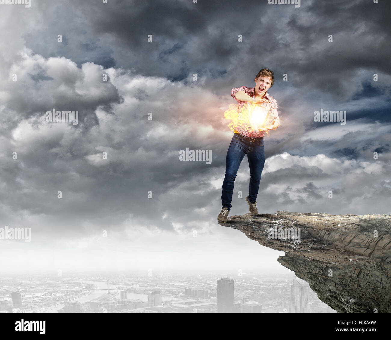Young man in casual throwing magic fire balls Stock Photo - Alamy
