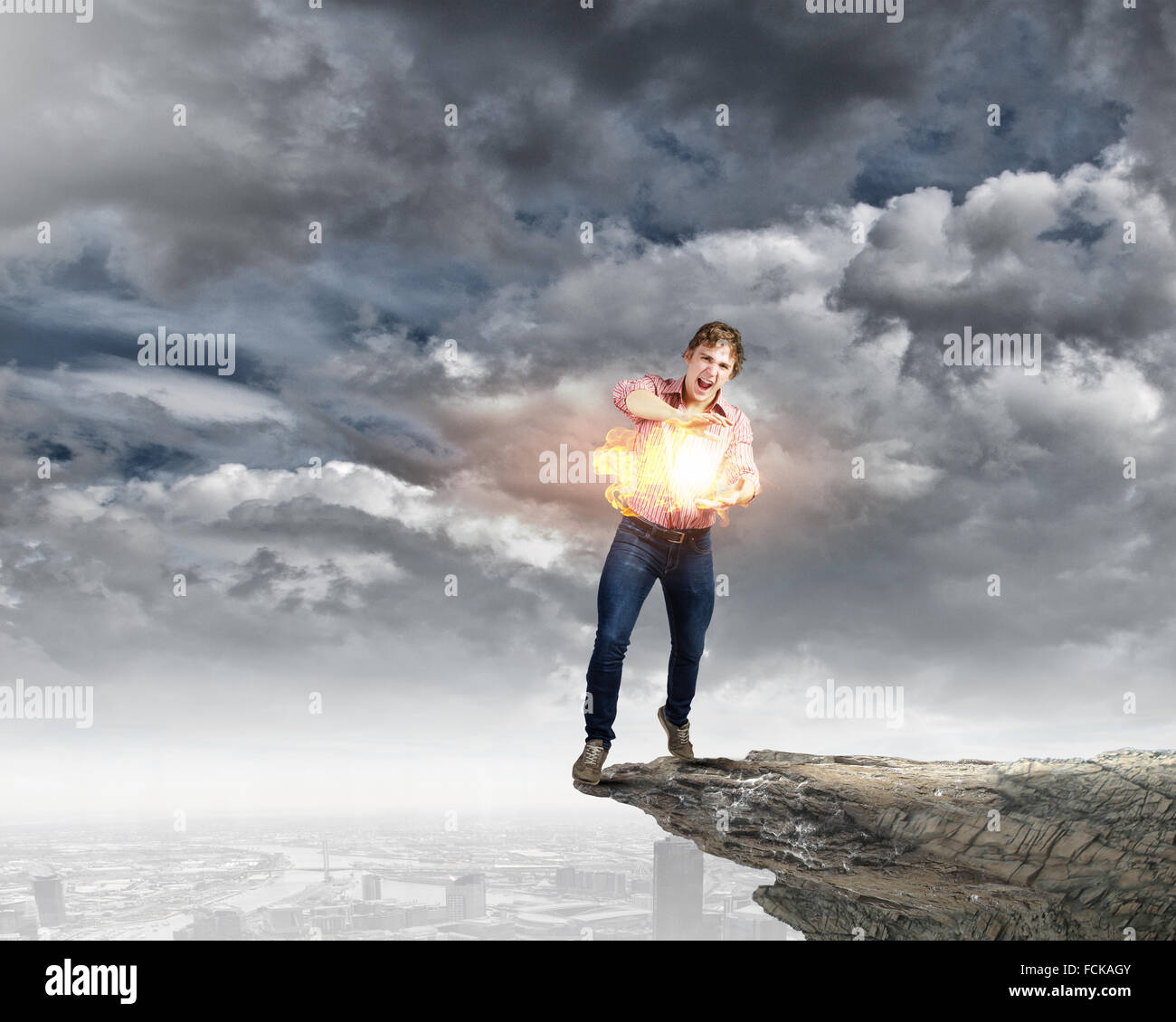 Young man in casual throwing magic fire balls Stock Photo - Alamy