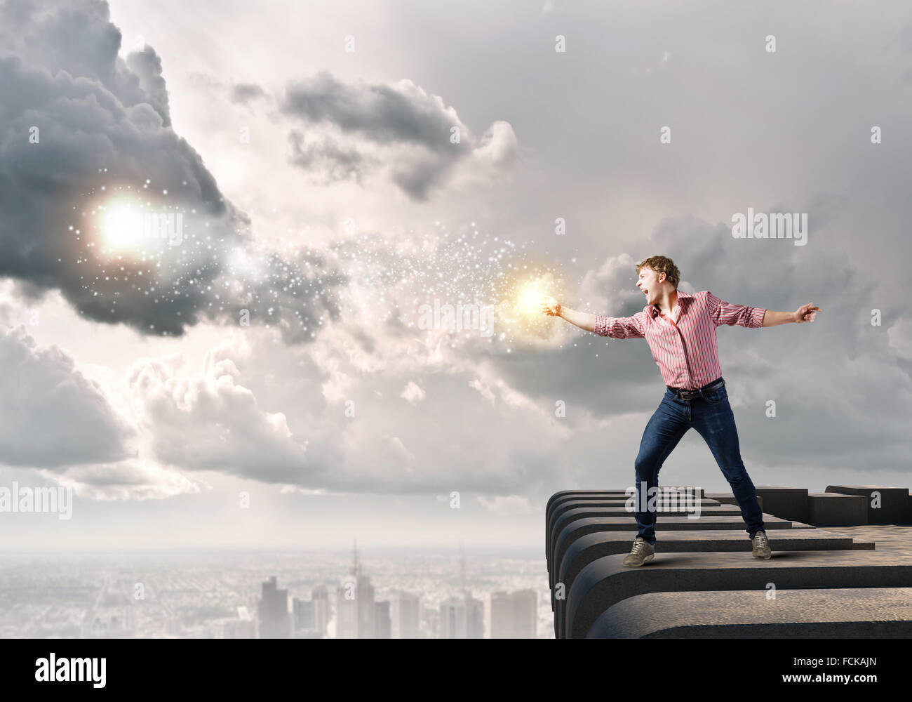Young man in casual throwing magic light Stock Photo - Alamy