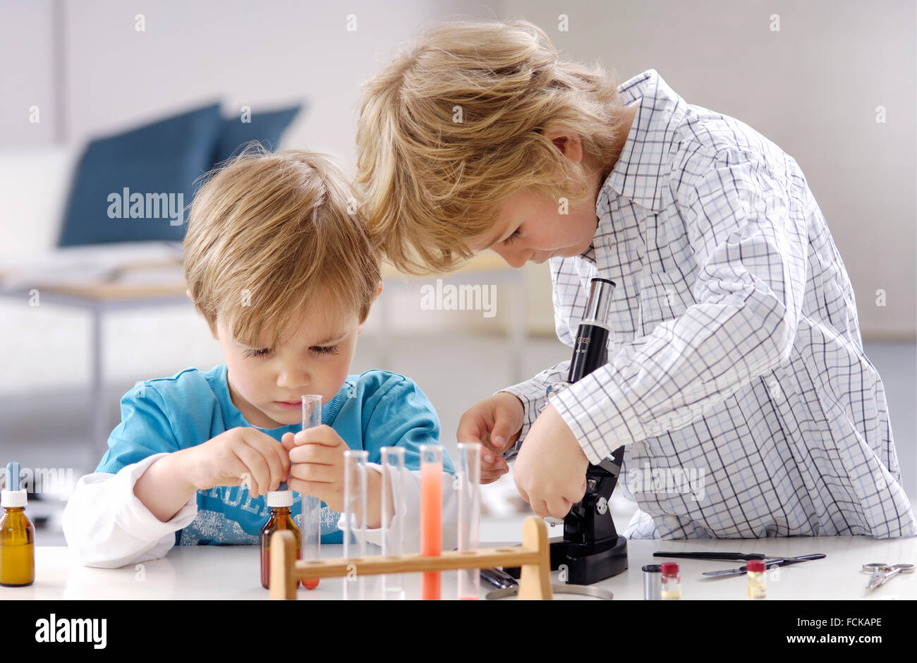 Two little boys playing utensils of chemical laboratory Stock Photo - Alamy