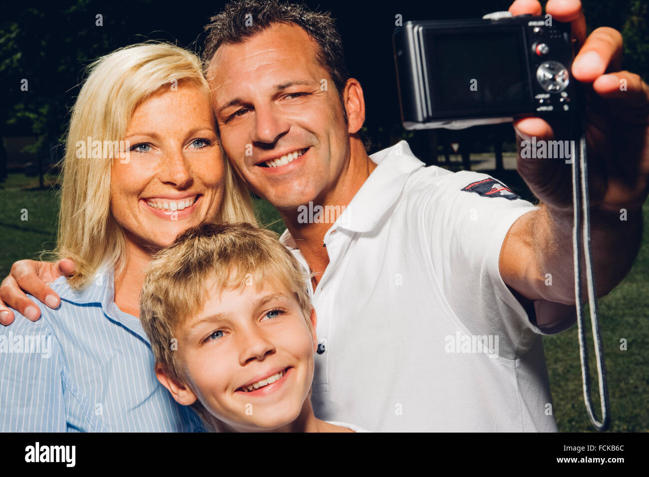 Happy family taking picture of themselves a digital camera Stock Photo ...