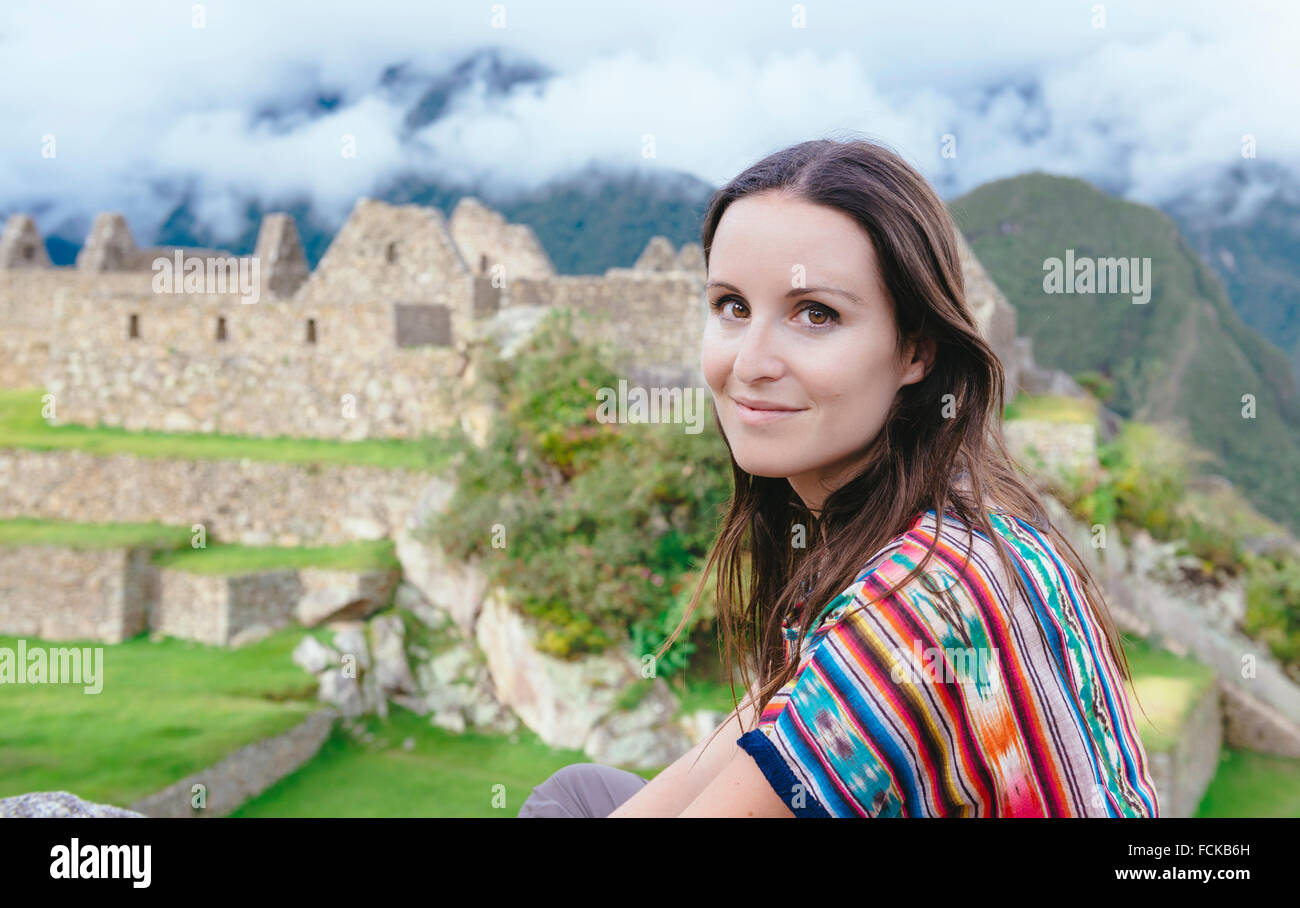 Peru smiling woman in Machu Picchu citadel Huayna Picchu mountain in ...