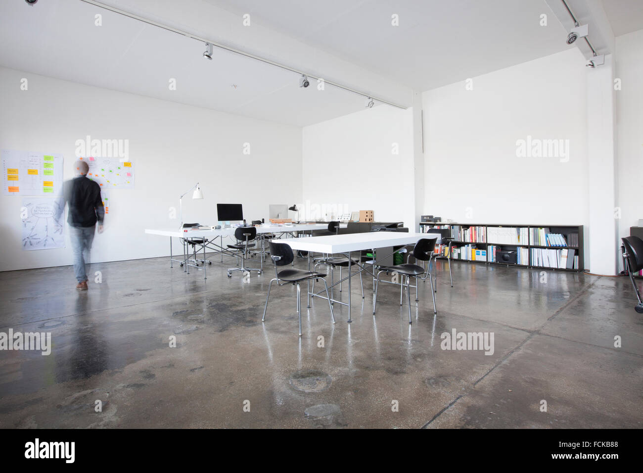 Businessman walking in conference room Stock Photo - Alamy