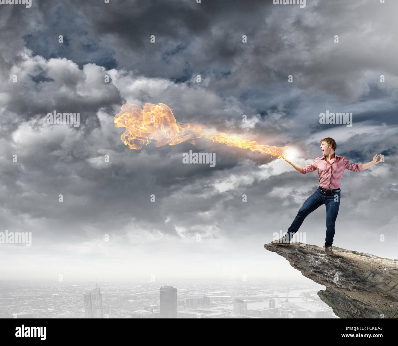Young man in casual throwing magic fire balls Stock Photo - Alamy
