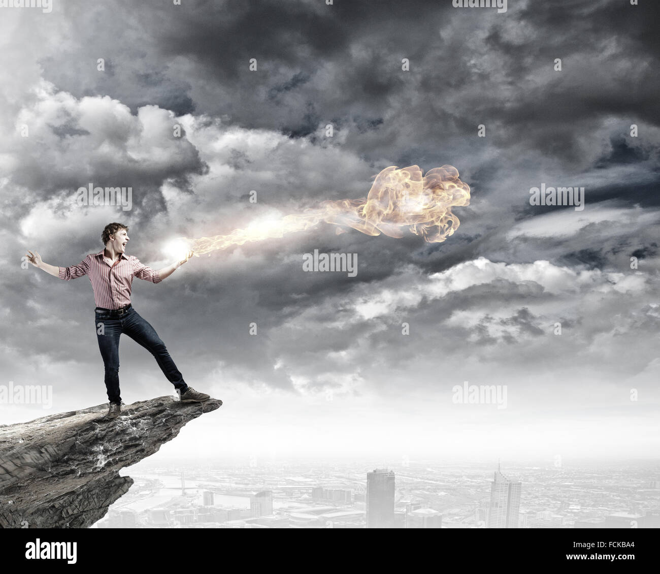 Young man in casual throwing magic fire balls Stock Photo - Alamy