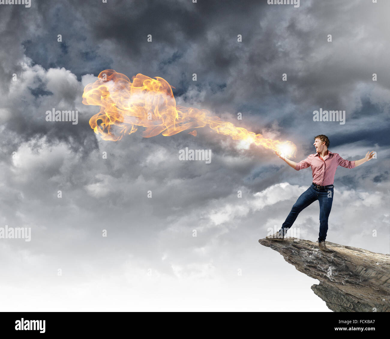 Young man in casual throwing magic fire balls Stock Photo - Alamy