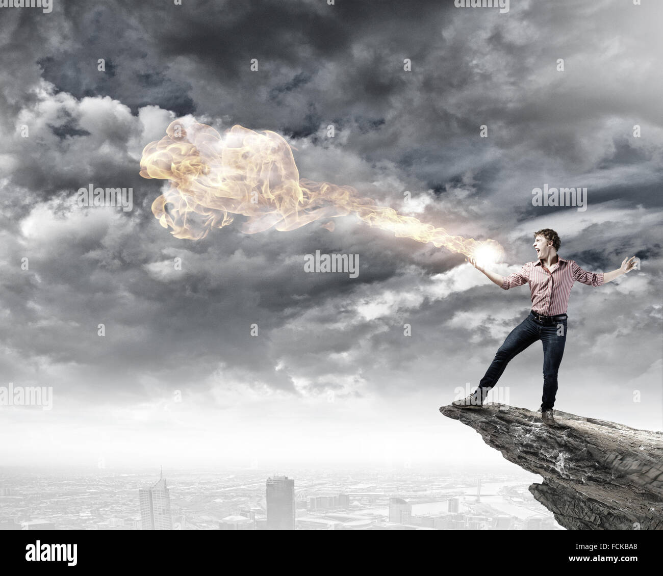 Young man in casual throwing magic fire balls Stock Photo - Alamy