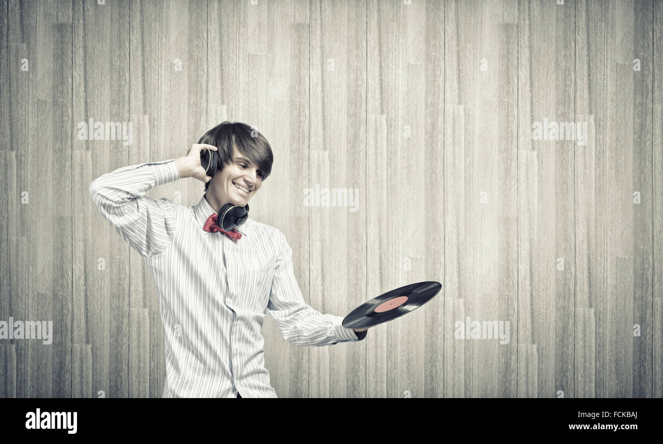 Young man dj wearing headphones and holding plate Stock Photo - Alamy