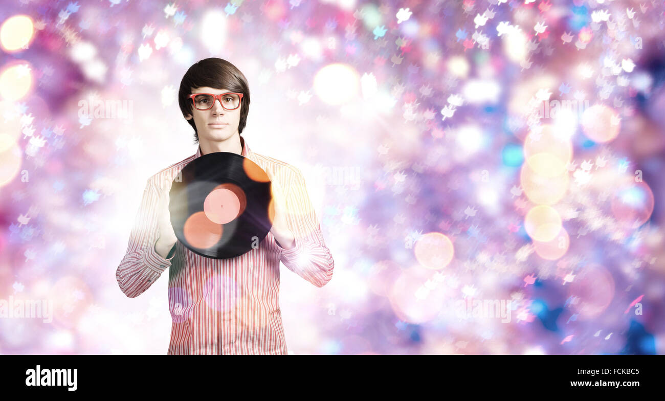 Young handsome man dj holding disco plate Stock Photo - Alamy