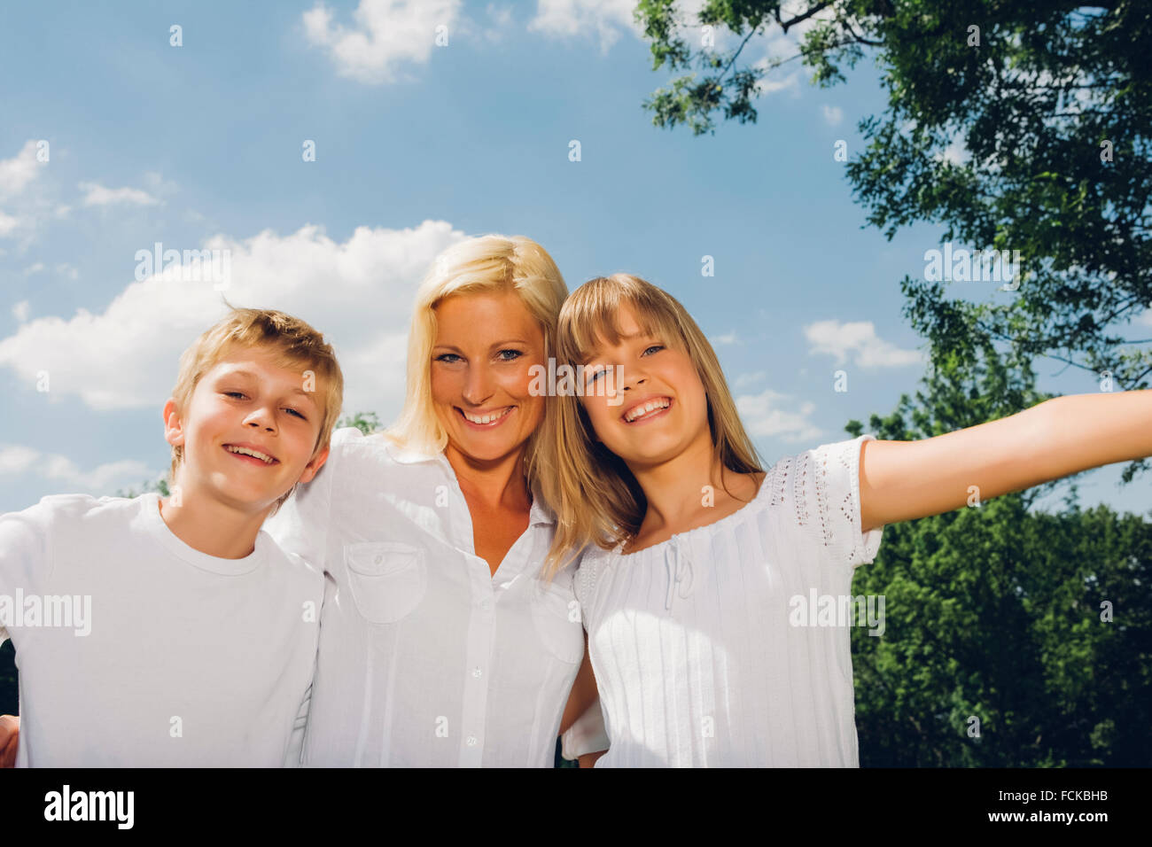 Portrait of happy mother her children in nature Stock Photo - Alamy