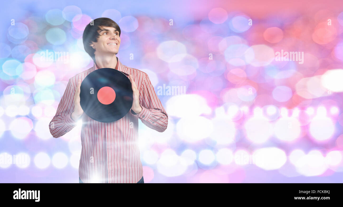 Young handsome man dj holding disco plate Stock Photo - Alamy