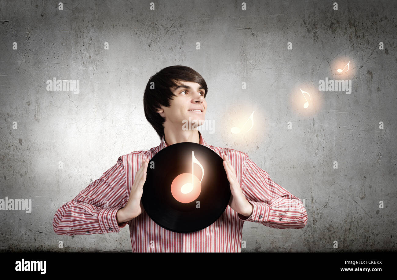 Young handsome man dj holding disco plate Stock Photo - Alamy