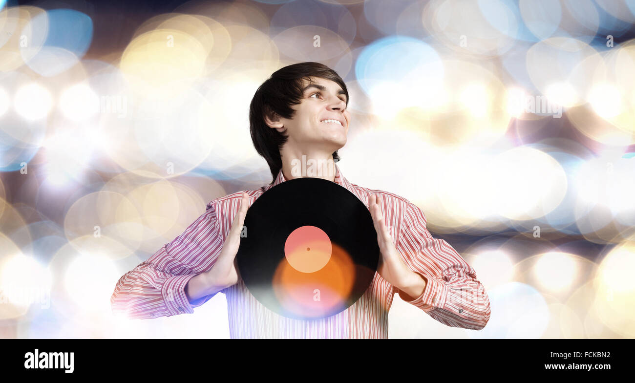 Young handsome man dj holding disco plate Stock Photo - Alamy