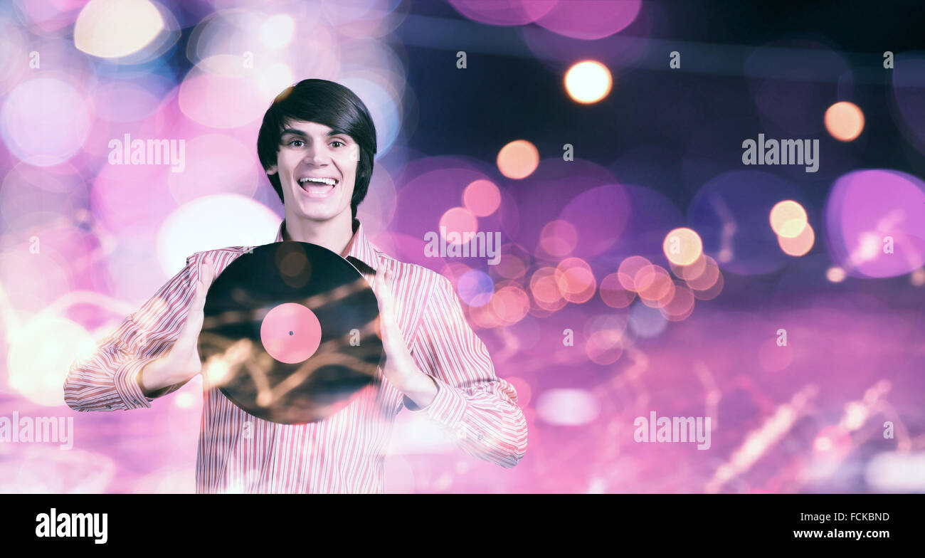 Young handsome man dj holding disco plate Stock Photo - Alamy