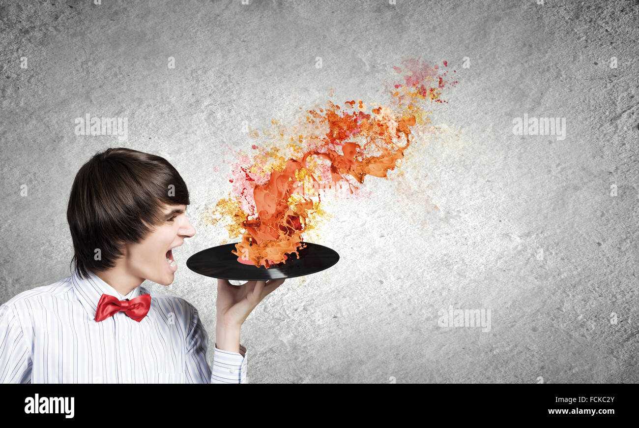 Young handsome man dj holding disco plate Stock Photo - Alamy