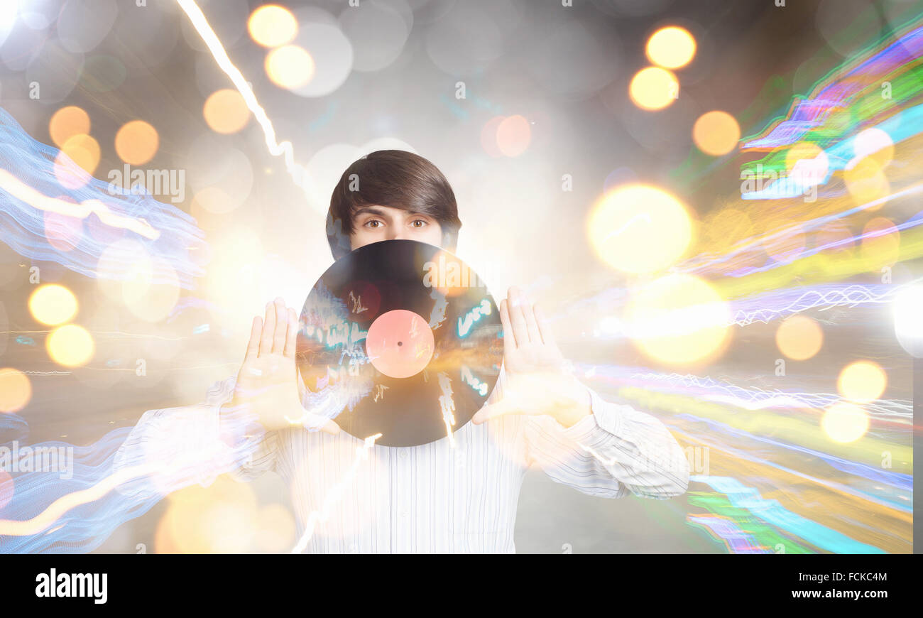 Young handsome man dj holding disco plate Stock Photo - Alamy