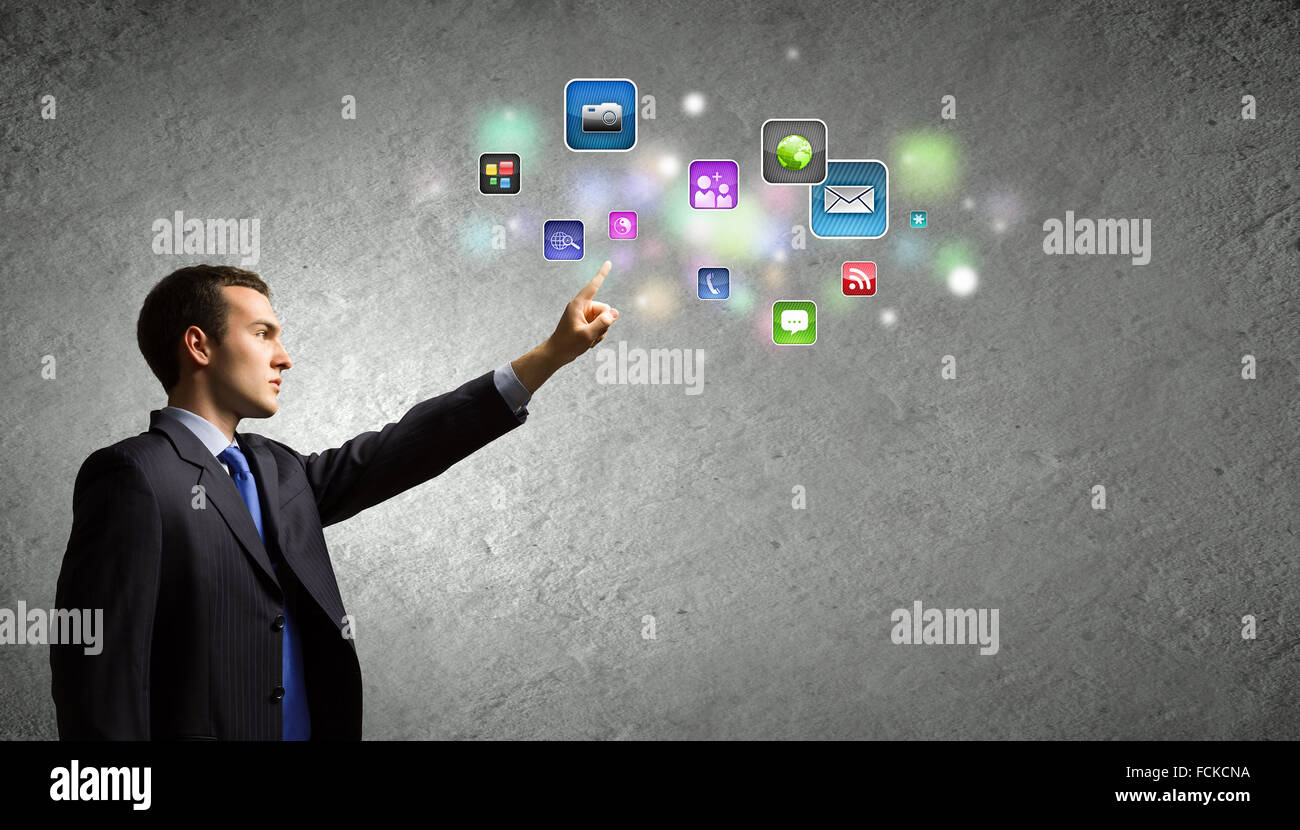 Young confident businessman and colorful media icons Stock Photo - Alamy
