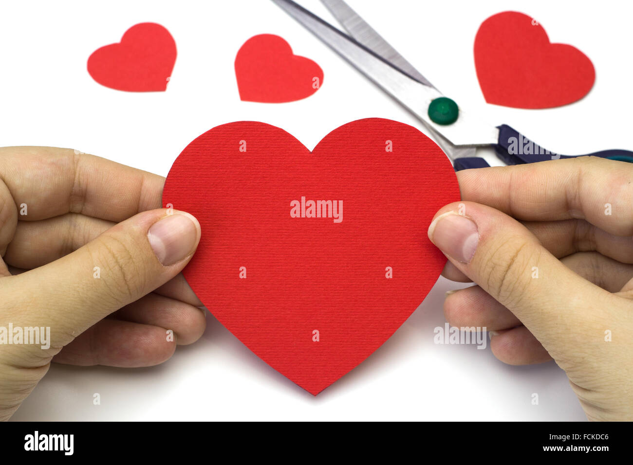 Creating red heart of colored paper pattern Stock Photo - Alamy