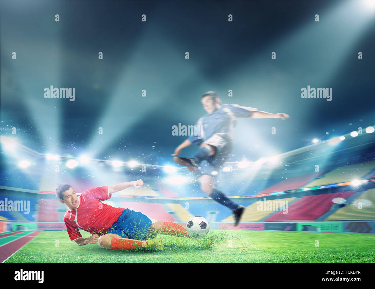 Two football player fighting for ball at stadium Stock Photo - Alamy