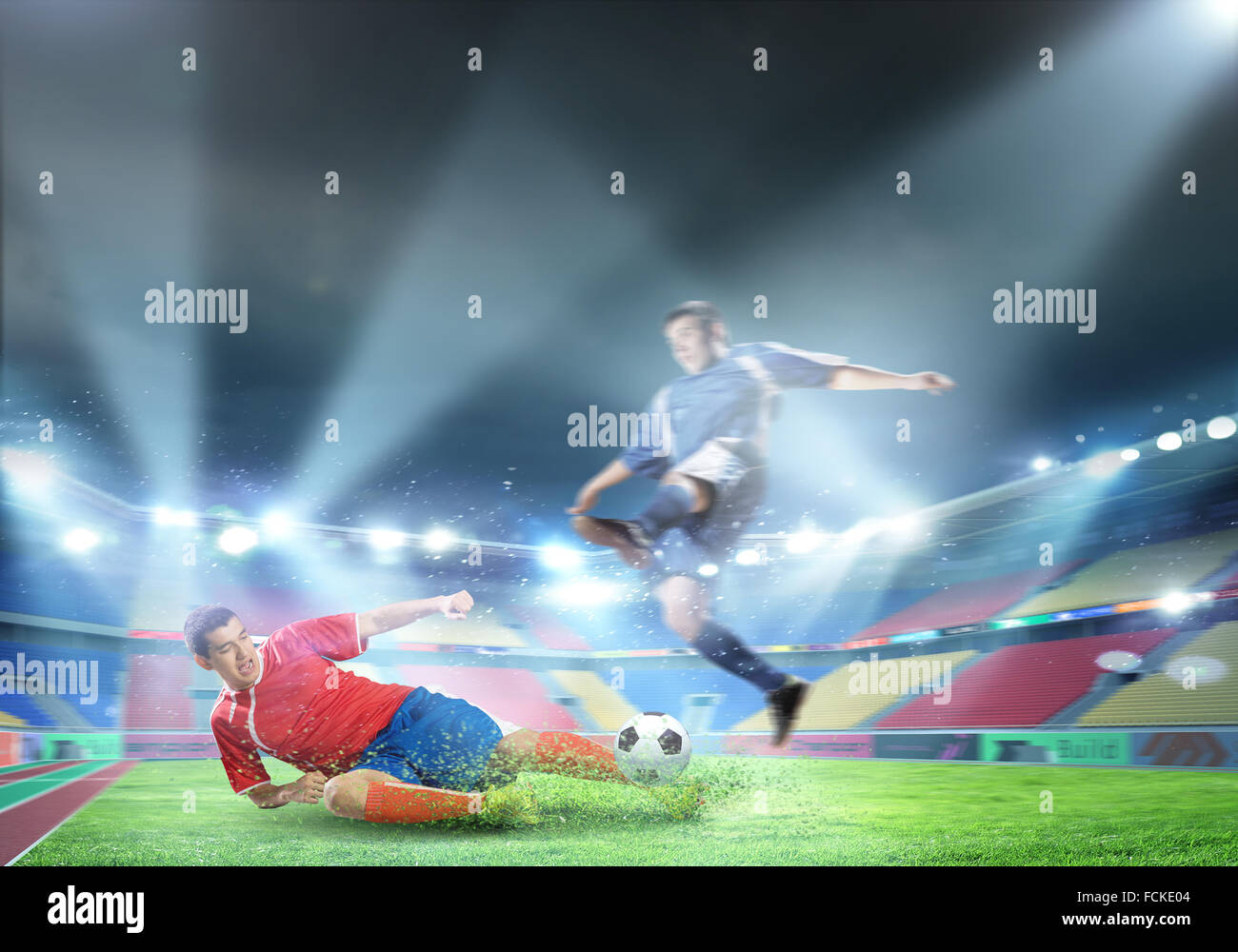 Two football player fighting for ball at stadium hi-res stock ...