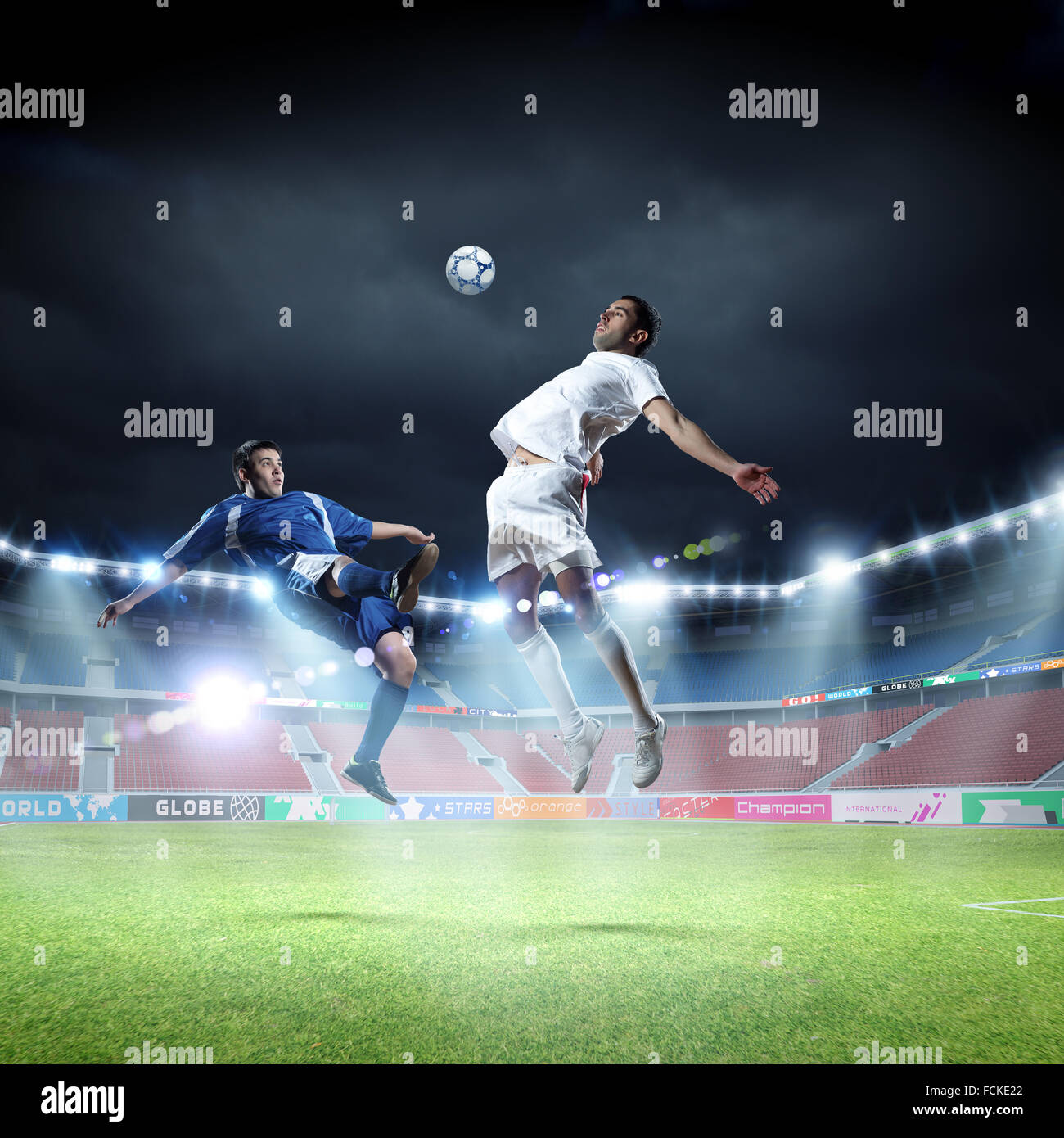 Two football player fighting for ball at stadium Stock Photo - Alamy
