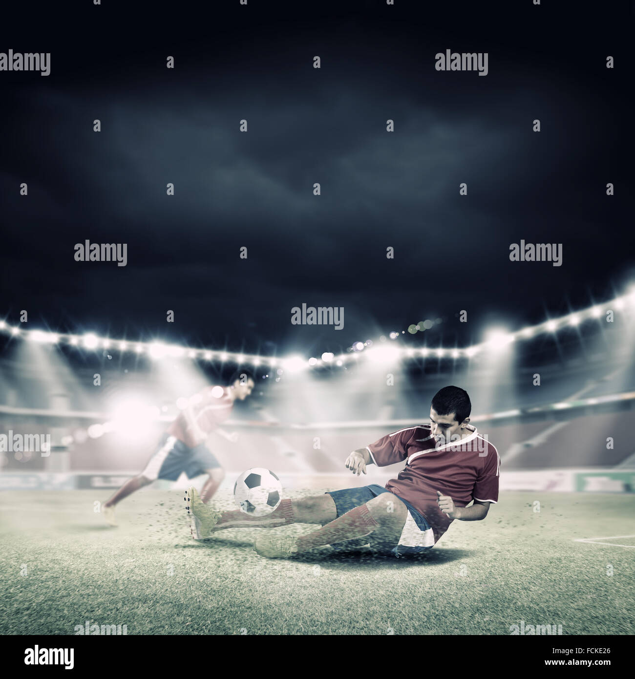 Two football player fighting for ball at stadium Stock Photo - Alamy