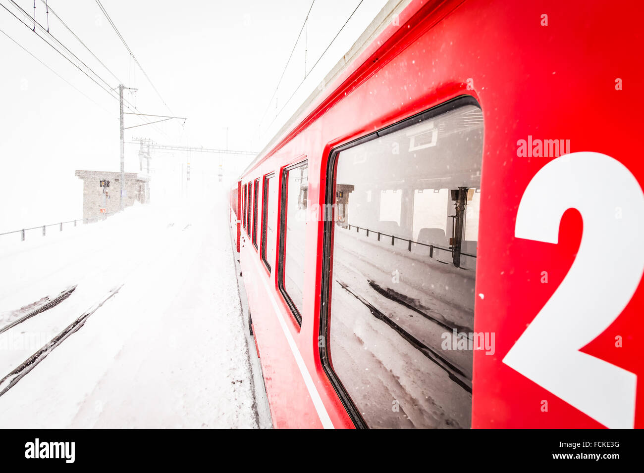 A red train in the middle of a desert of snow Stock Photo - Alamy
