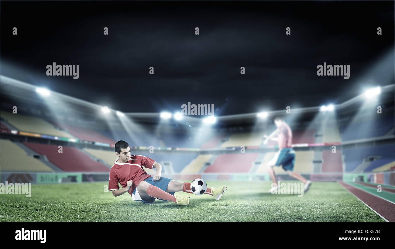 Two football player fighting for ball at stadium Stock Photo - Alamy