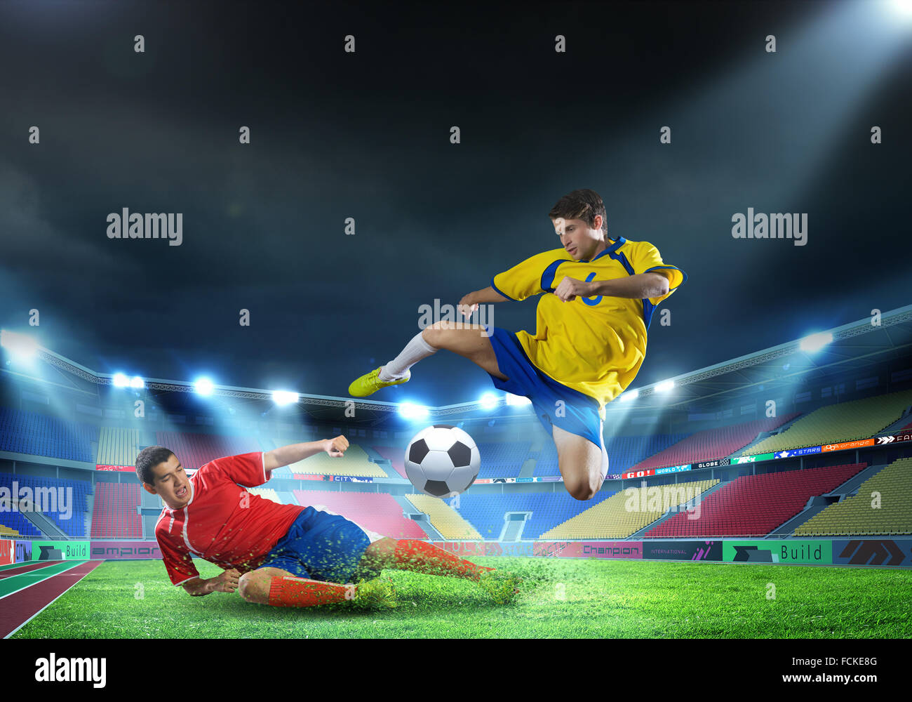 Two football player fighting for ball at stadium Stock Photo - Alamy