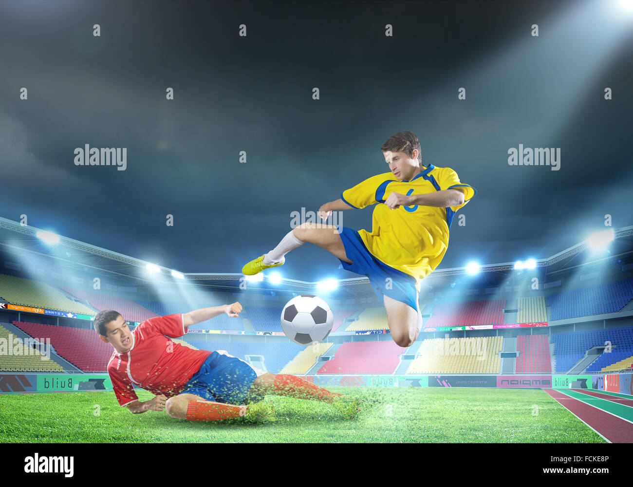 Two football player fighting for ball at stadium Stock Photo - Alamy