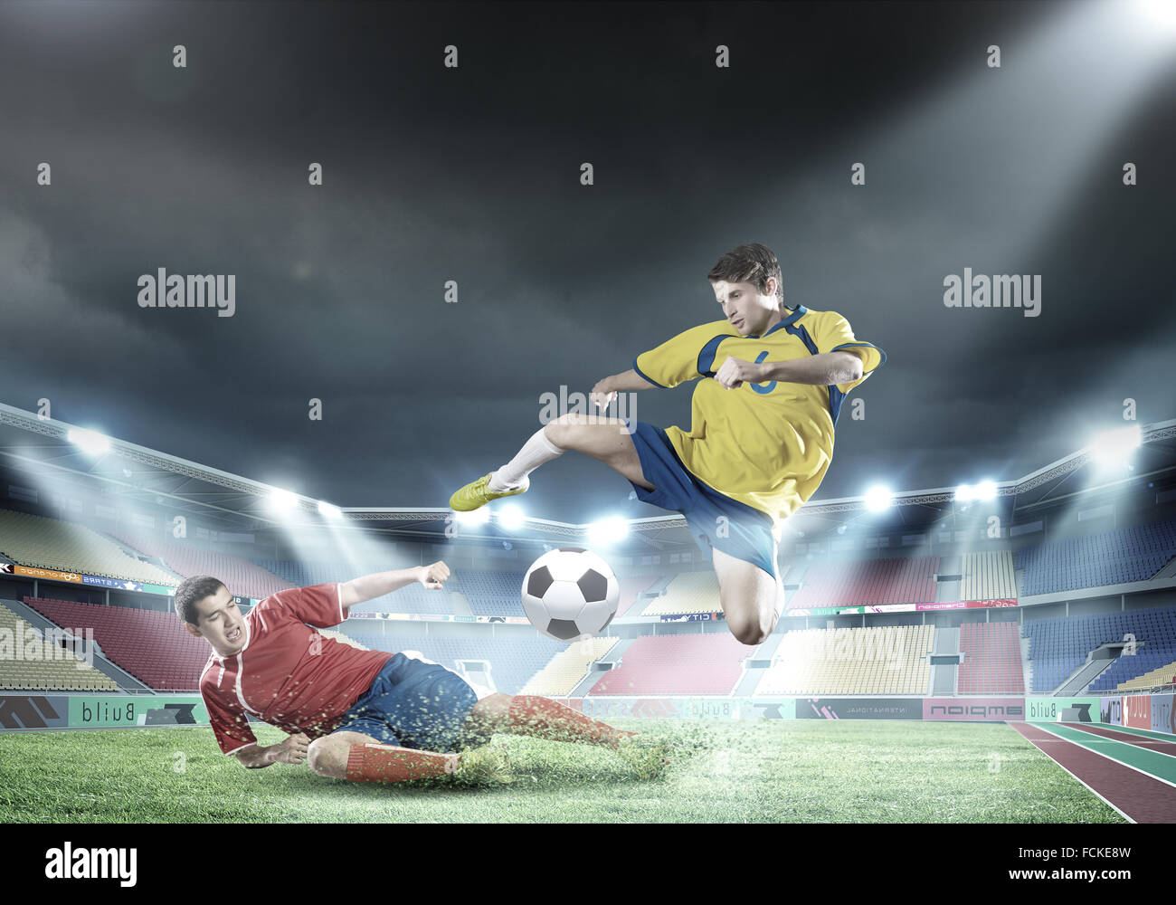 Two football player fighting for ball at stadium Stock Photo - Alamy