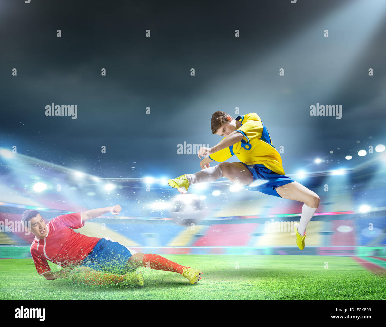 Two football player fighting for ball at stadium Stock Photo - Alamy