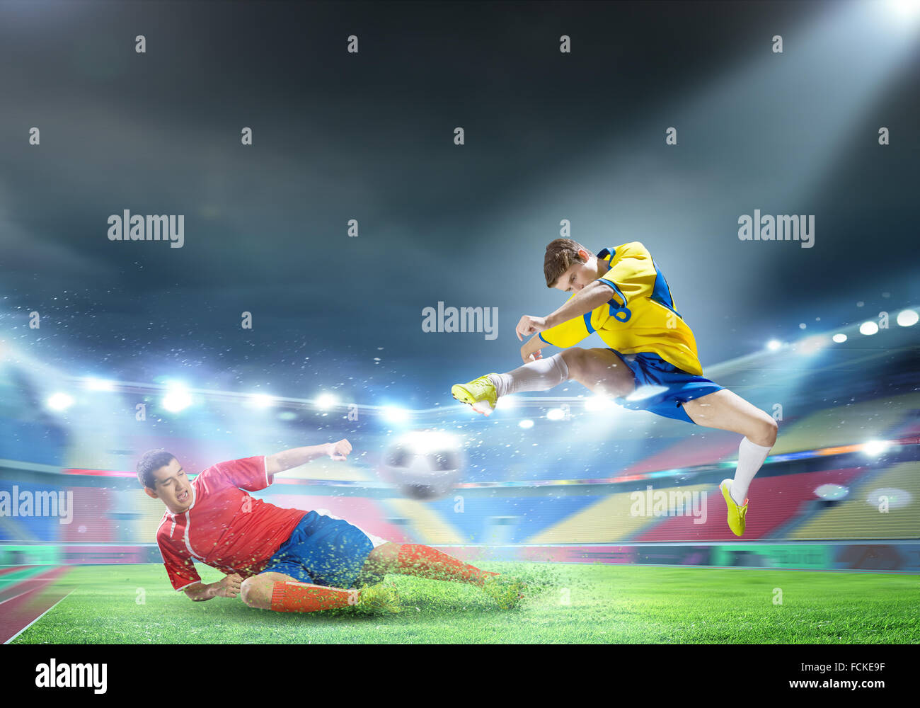Two football player fighting for ball at stadium Stock Photo - Alamy
