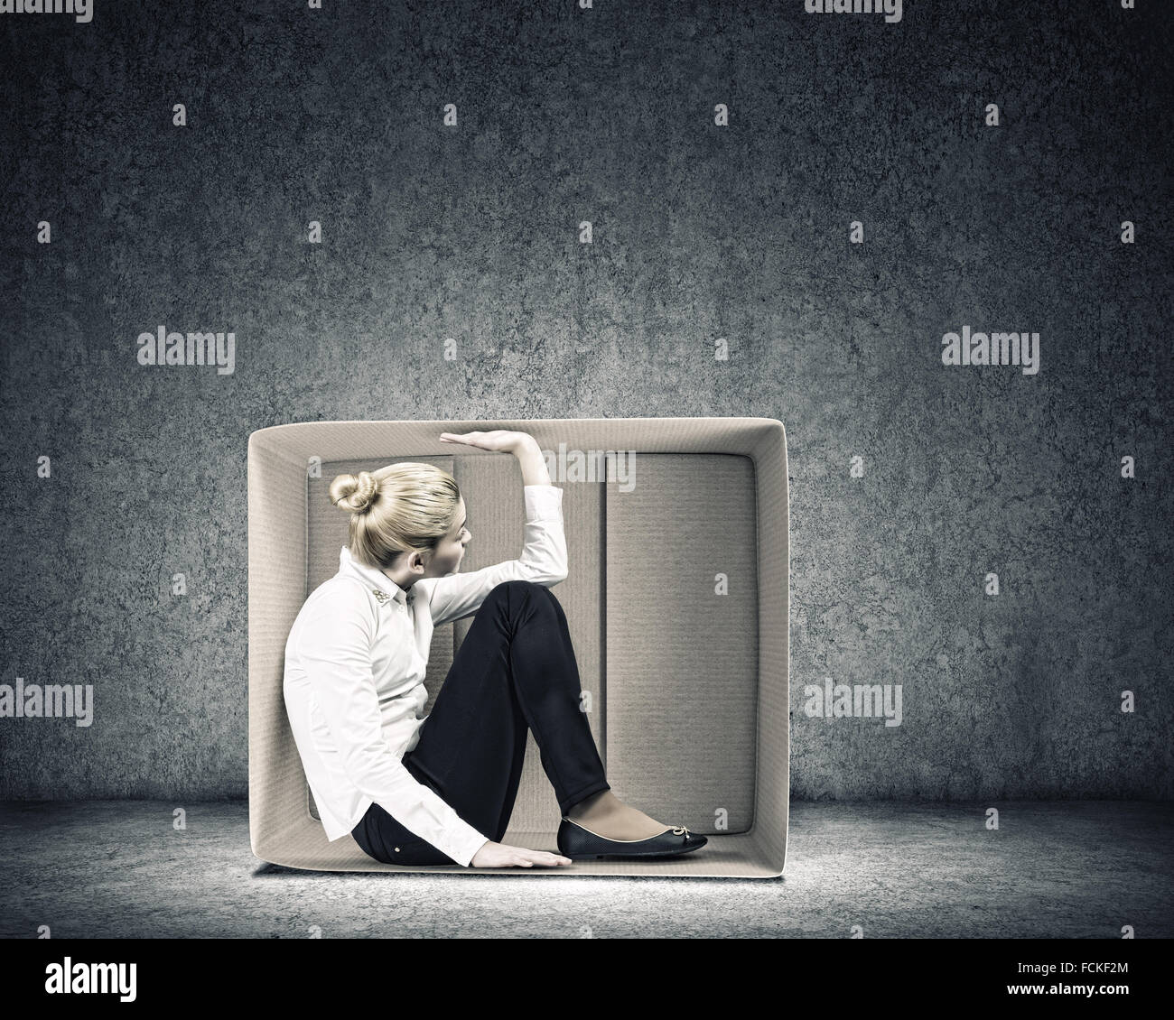 Young businesswoman trapped in carton box Stock Photo - Alamy
