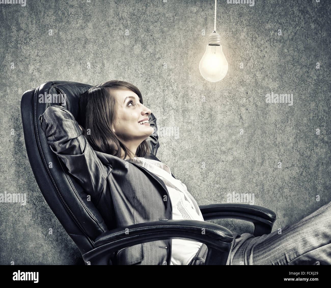 Young confident businesswoman sitting in chair with legs up Stock Photo ...