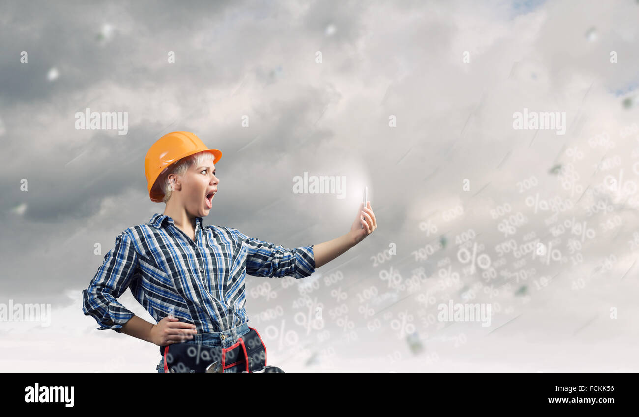 Young emotional woman mechanic screaming in mobile phone Stock Photo ...