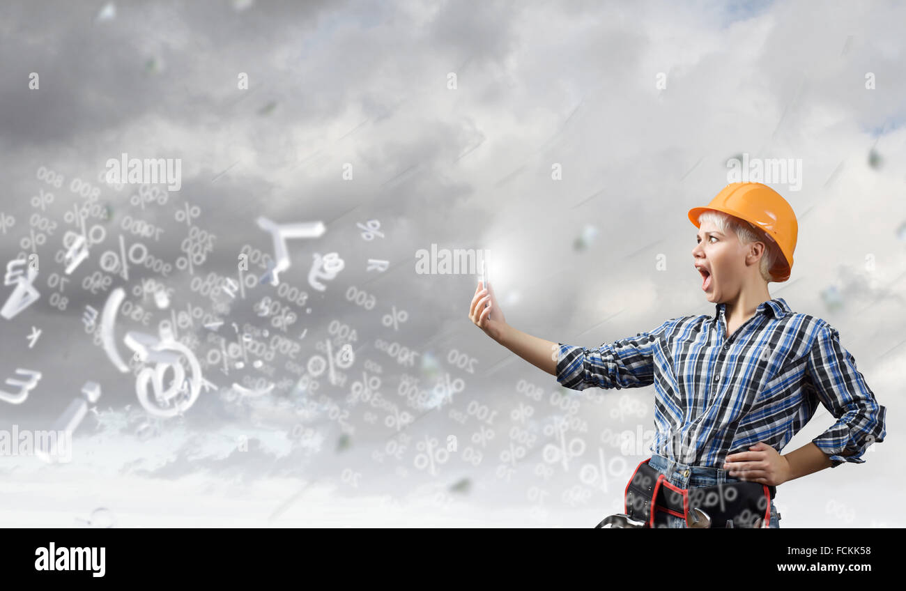 Young emotional woman mechanic screaming in mobile phone Stock Photo ...