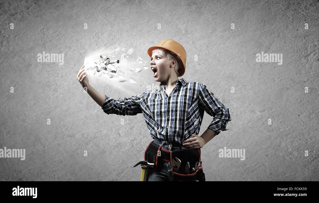 Young emotional woman mechanic screaming in mobile phone Stock Photo ...