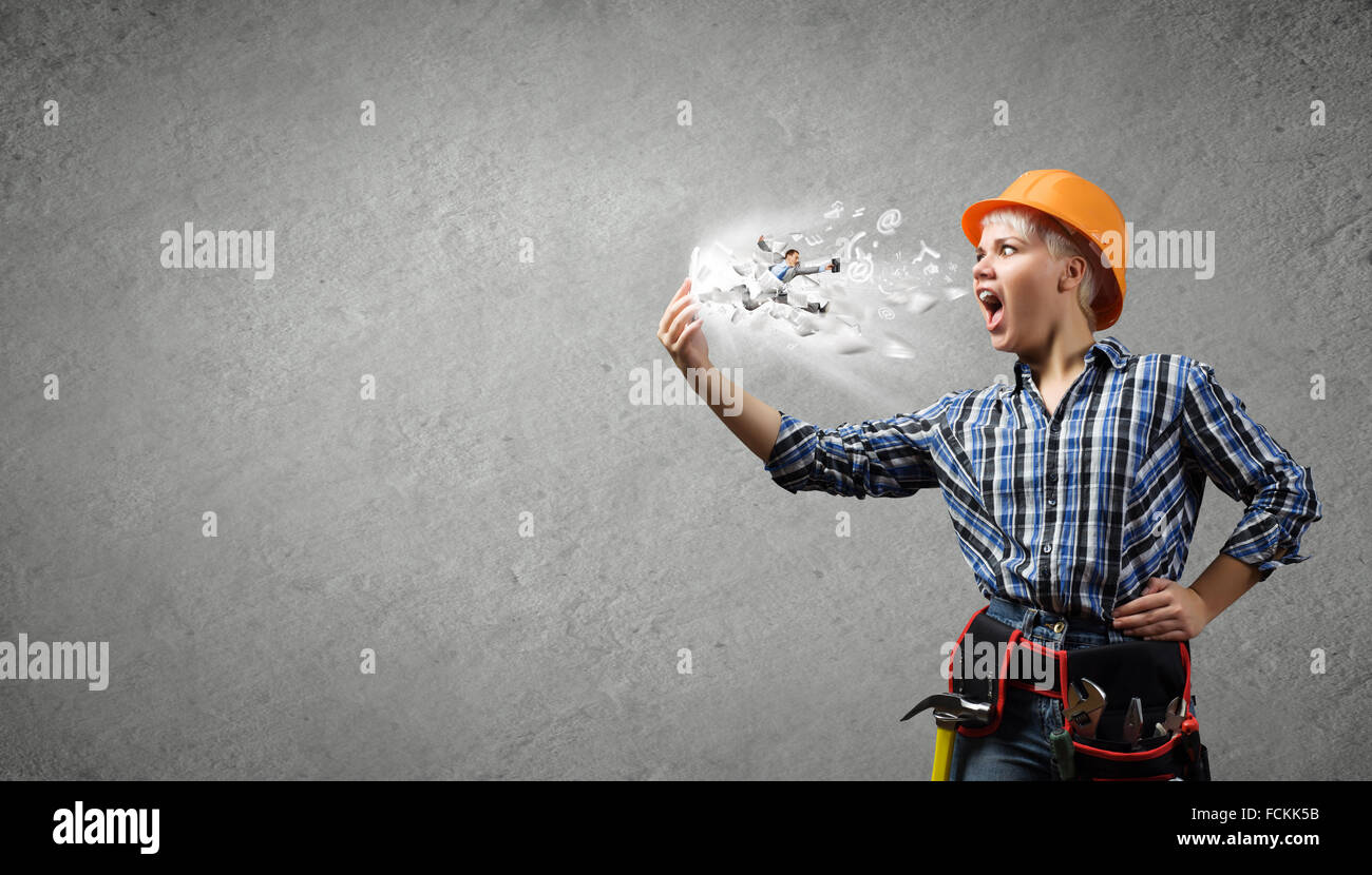 Young emotional woman mechanic screaming in mobile phone Stock Photo ...