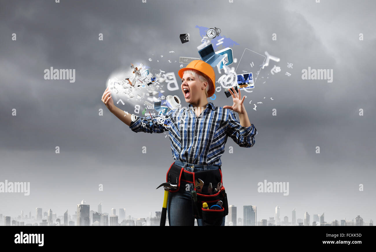 Young emotional woman mechanic screaming in mobile phone Stock Photo ...